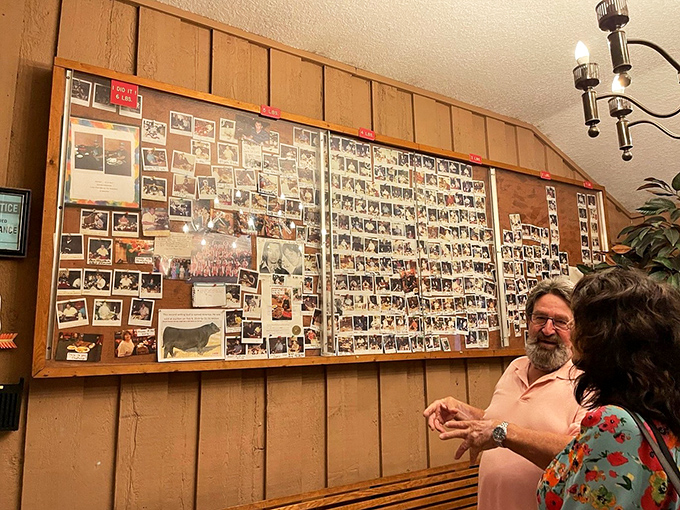 A wall of memories thicker than a well-done steak. Each photo tells a story of satisfied taste buds and loosened belts.