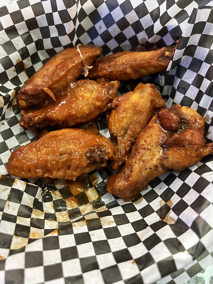 These wings are hotter than a '55 Thunderbird's engine on a summer day. Crispy, saucy, and guaranteed to leave your fingers stickier than a drive-in movie theater floor.