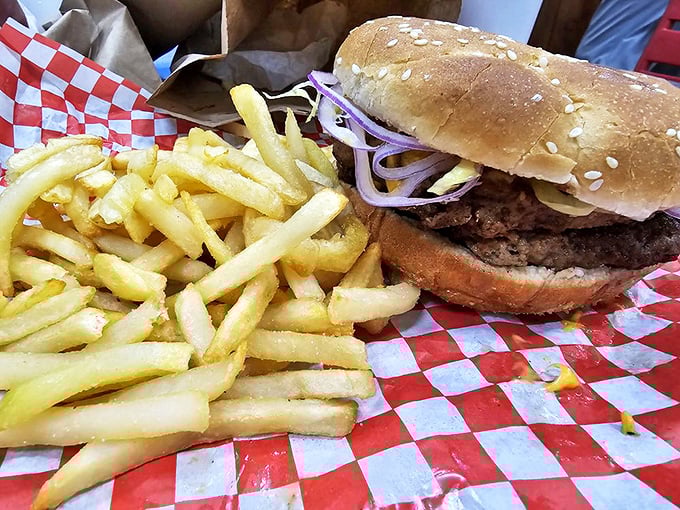 Burger bliss awaits! This bad boy's stacked higher than a Jenga tower, and twice as satisfying when it topples.