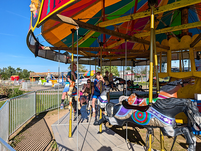 Round and round we go on this merry menagerie! The carousel's a whirl of color that'll make you dizzy with delight.