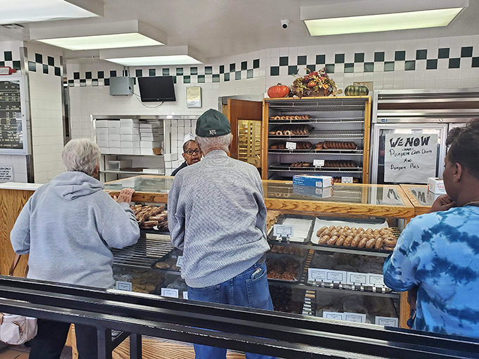 Pilgrims at the altar of pastry perfection. These customers know the secret to happiness - it's round, it's fried, and it's absolutely irresistible.