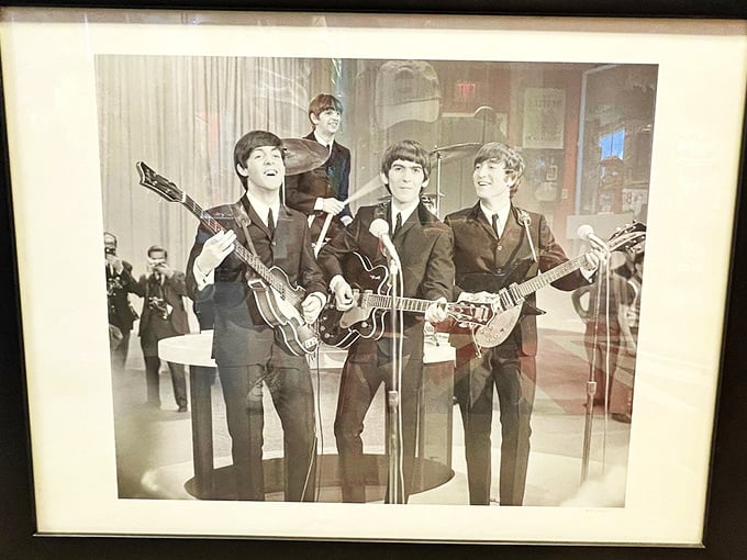 Freeze frame on fame! This iconic shot captures the lads in their prime, ready to make music history on The Ed Sullivan Show.