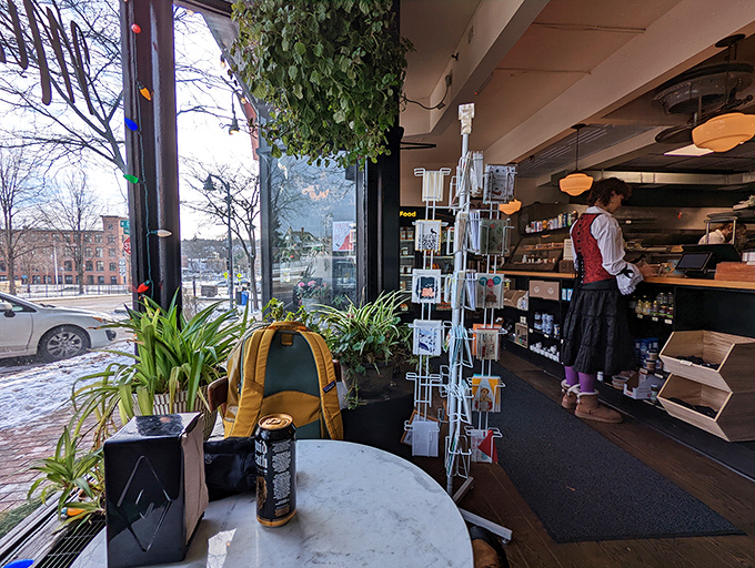 A cozy corner where misery doesn't stand a chance. Plants, postcards, and the promise of good food create a welcoming vibe.