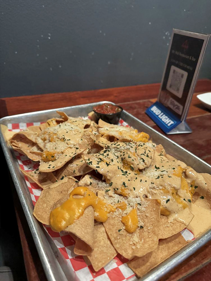 Dive into these loaded nachos, perfectly smothered in creamy cheese and savory toppings, paired with fresh salsa for your enjoyment.