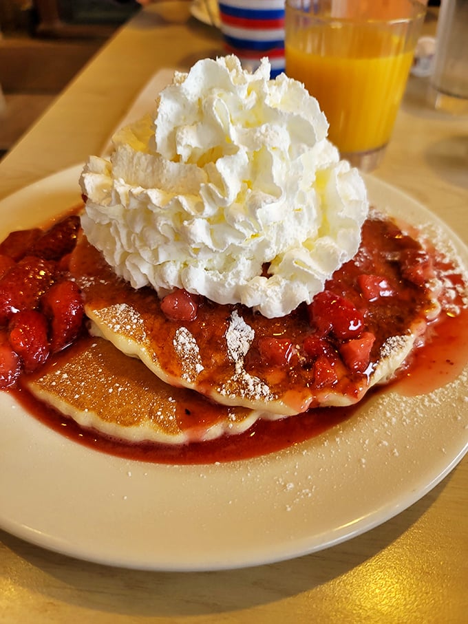 Strawberry pancakes that look like they're auditioning for a starring role in a breakfast blockbuster. That whipped cream! Those berries!