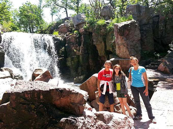 Waterfall photobomb! These happy hikers found the perfect backdrop for their "wish you were here" moment.
