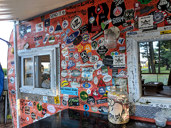 Wall of fame! Each sticker tells a story of BBQ pilgrims who've made the journey to this smoky shrine.