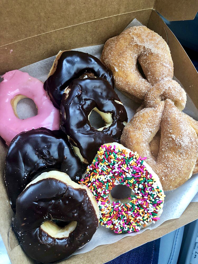 A rainbow of indulgence! This box of assorted donuts is like a treasure chest for your taste buds &ndash; each one a delicious discovery.