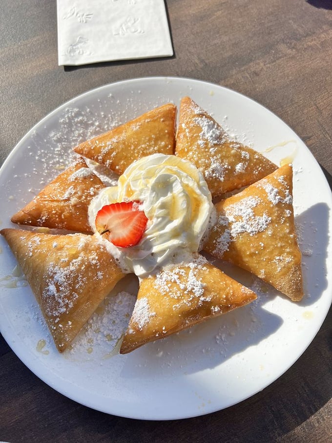 Beignets that transport you straight to New Orleans! Dusted with powdered sugar and served with a dollop of cream, these little pillows of joy are a sweet tooth's dream come true.