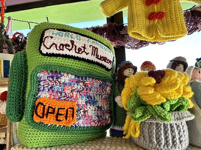 Talk about wearing your heart on your sleeve! This crocheted 'OPEN' sign welcomes yarn enthusiasts with the warmth of a hand-knit sweater on a chilly day.