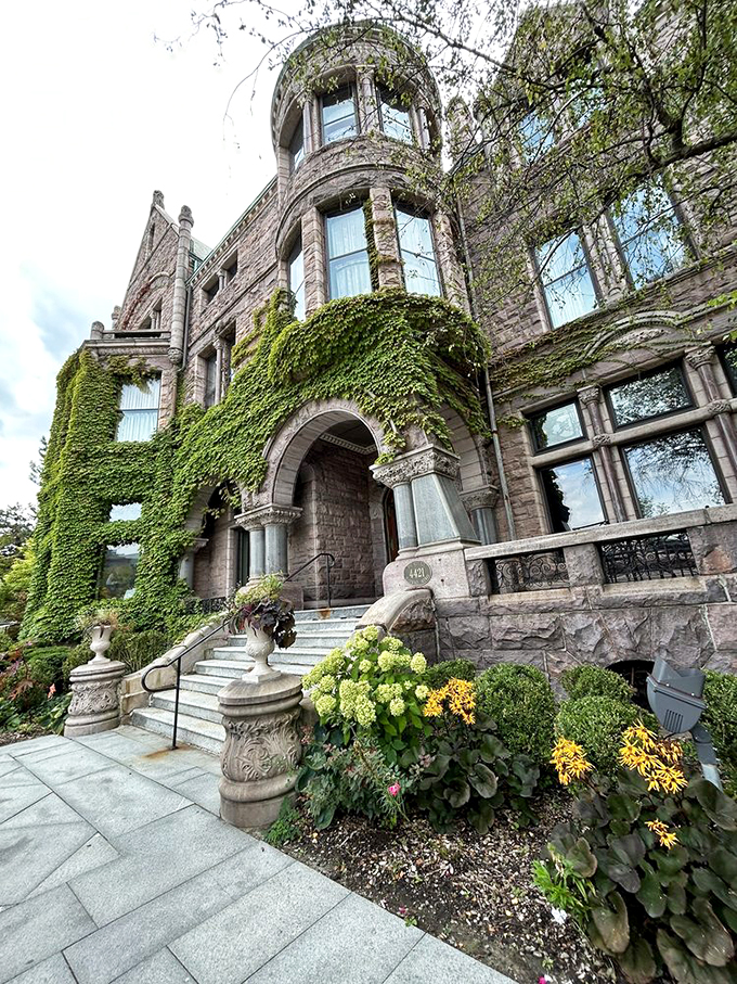 Nature meets architecture in perfect harmony. The Whitney's entrance is a floral-framed invitation to step into Detroit's storied past.