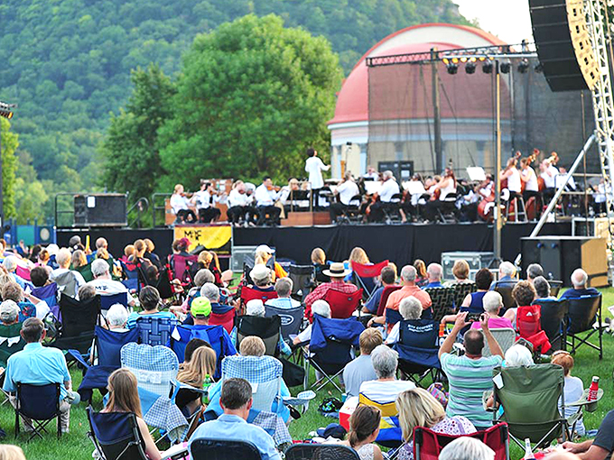 Riverside concert: Where music meets nature's amphitheater. It's like Woodstock, but with comfier chairs and fewer mud fights.