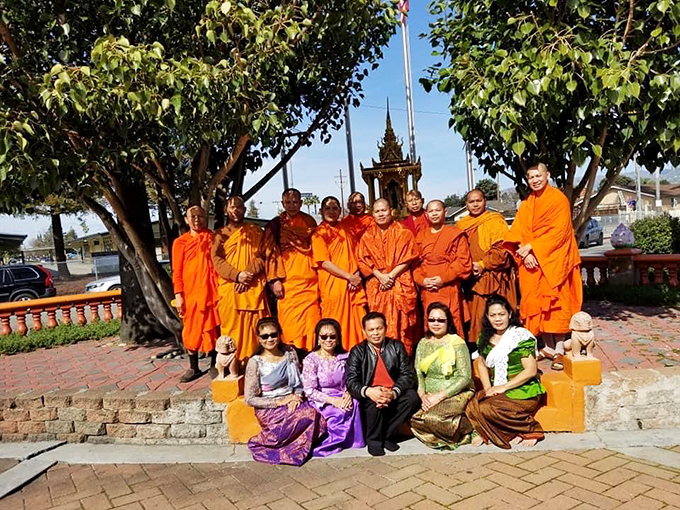 Orange you glad you came? These monks and community members bring the temple to vibrant life.