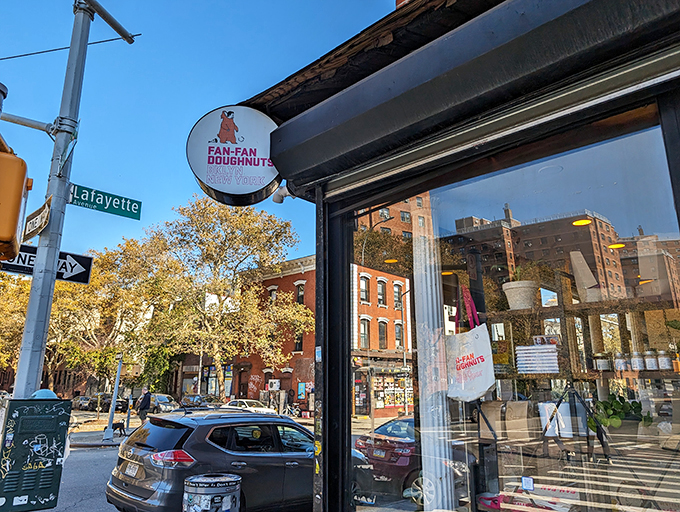 The bat-signal for donut lovers! This sign is like a lighthouse, guiding sweet-toothed sailors safely to shore.