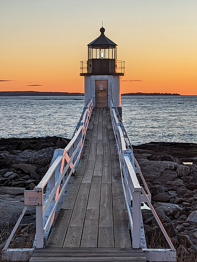 Sunset spectacular: As day bids adieu, Marshall Point Lighthouse stands ready to guide ships through the twilight dance of sea and sky.
