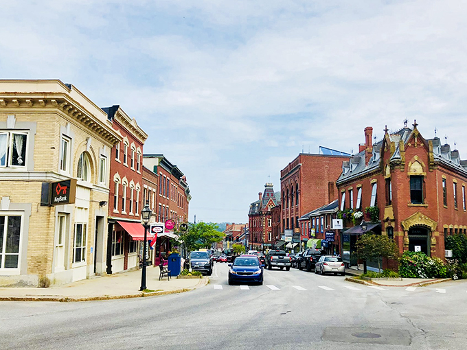 Belfast's Main Street: Where Norman Rockwell meets coastal charm. Brick buildings and colorful storefronts create a scene so quaint, you'll swear you've stepped into a painting.