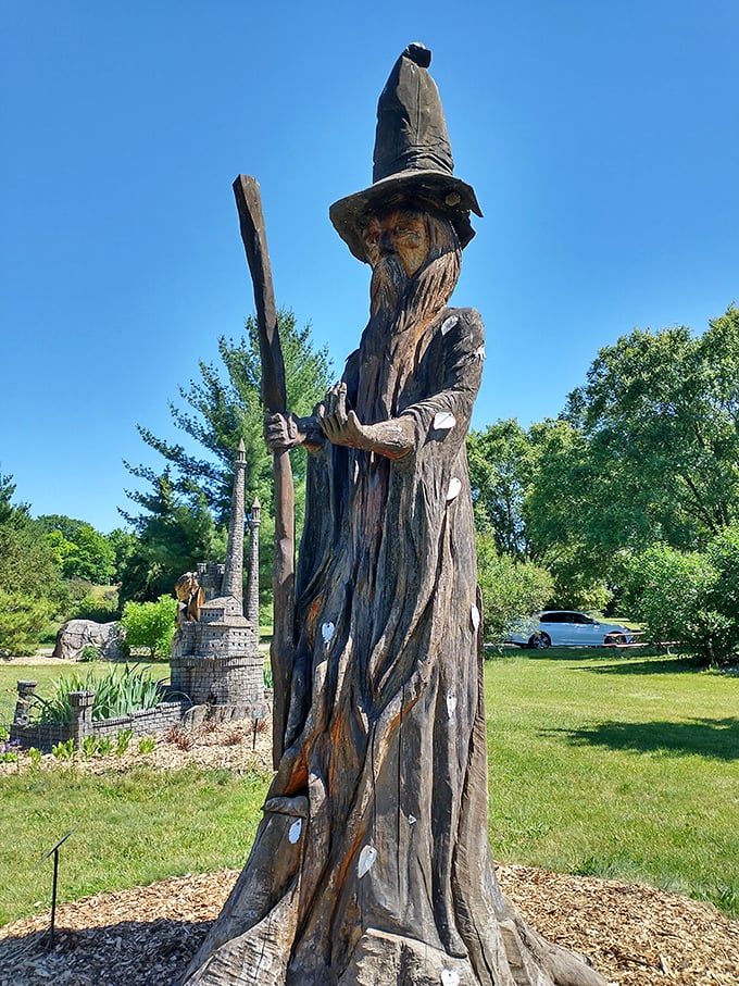 Gandalf's long-lost cousin? This wooden wizard stands tall, guarding a miniature castle fit for a fairy tale king.