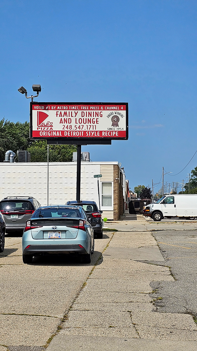 Loui's Pizza: Where time stands still, but the pizza keeps coming! This retro sign promises family dining and Detroit-style delights since 1954.