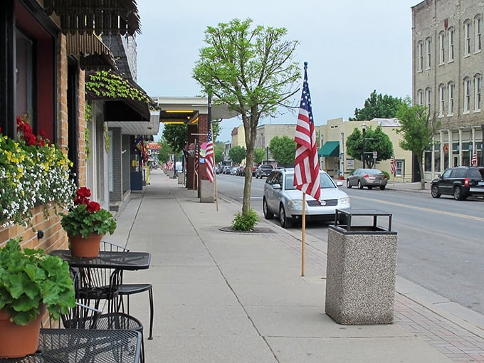 Pentwater: Where flags wave and flowers bloom! Main Street's charm could make Norman Rockwell reach for his paintbrush.