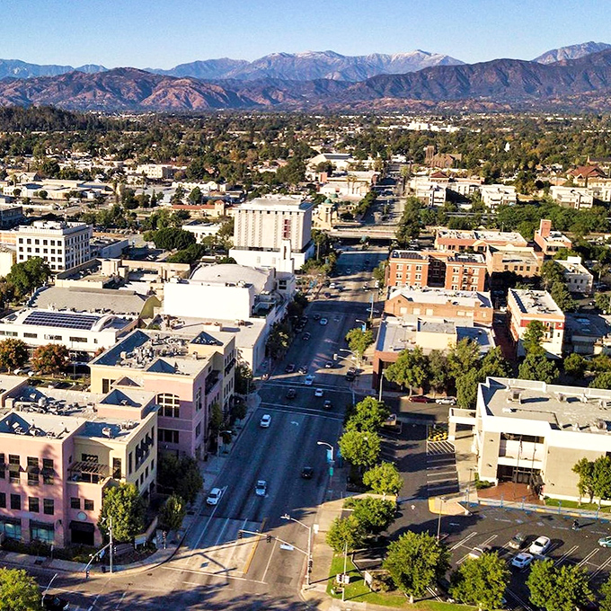 Pomona: Where the mountains meet Main Street! This aerial view showcases the city's blend of urban charm and natural beauty.