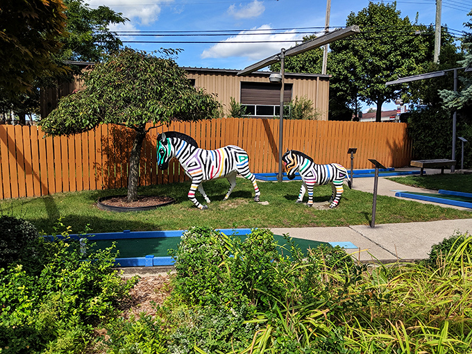 Zebra crossing? More like zebra putting! These striped spectators at Putterz are ready to critique your swing.