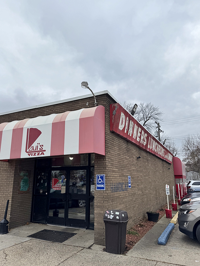 Step into a pizza time capsule! Loui's red-and-white awning beckons you to a world of cheesy, crusty perfection.
