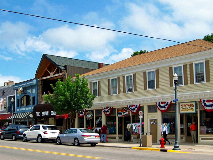Summertime bliss in Pentwater! Stroll past quaint shops and patriotic displays &ndash; it's like stepping into a vintage postcard.