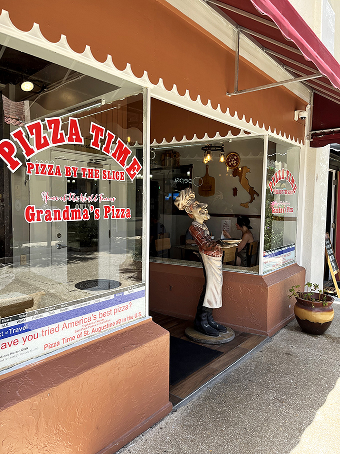 Grandma's got game! This charming chef statue guards the entrance to Pizza Time, where tradition meets taste bud nirvana.