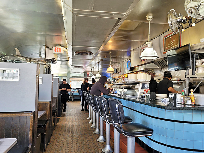 Welcome to the breakfast battleground! This bustling diner interior is where pancake dreams and bacon fantasies come to life.