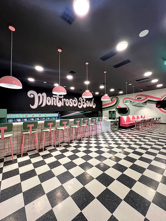 Checkered floors and bubblegum-pink lights? It's like the 1950s exploded in the best possible way!