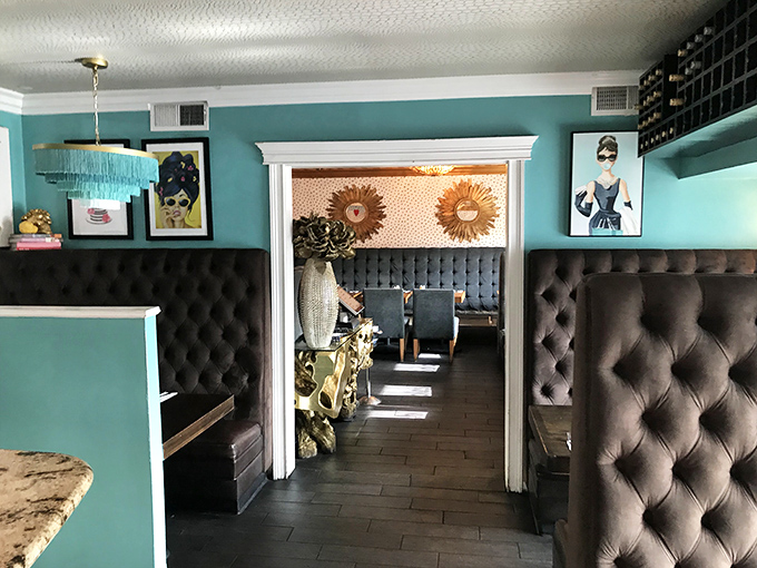 Step into a world where teal walls meet leather luxury. It's like Audrey Hepburn decided to open a diner &ndash; classy with a side of sass.