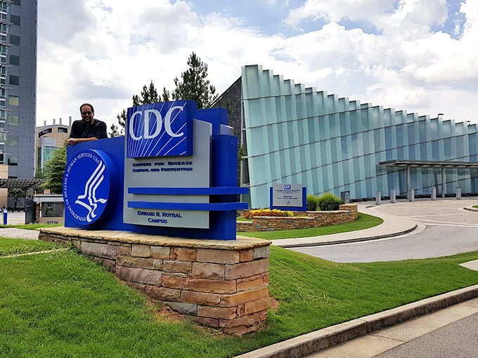 "Honey, I shrunk the germs!" The CDC's larger-than-life sign dwarfs visitors, setting the stage for a journey into the realm of the infinitesimal.