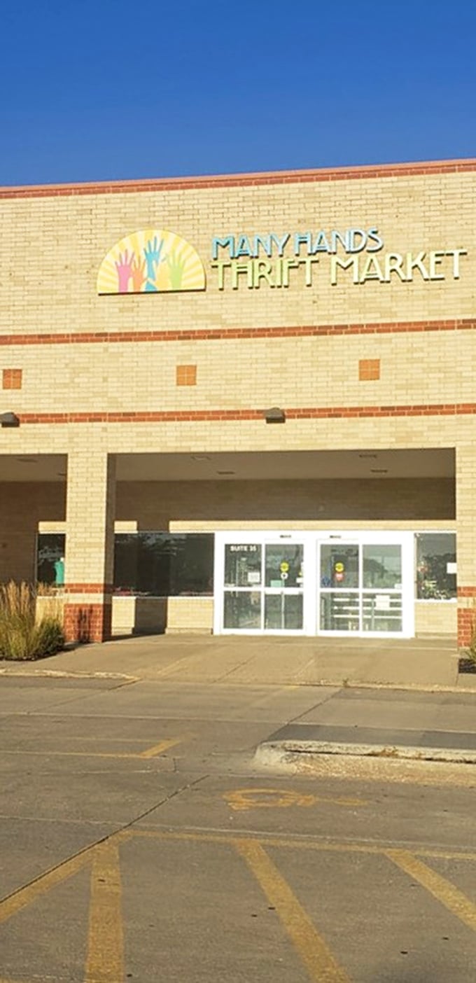 A rainbow of possibilities awaits! The vibrant sign above Many Hands Thrift Market's entrance is like a pot of gold at the end of a thrifting rainbow.