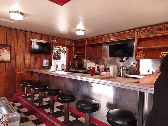 Step into a Norman Rockwell painting come to life. This cozy interior, with its wood paneling and counter seating, whispers tales of countless shared meals and laughter.