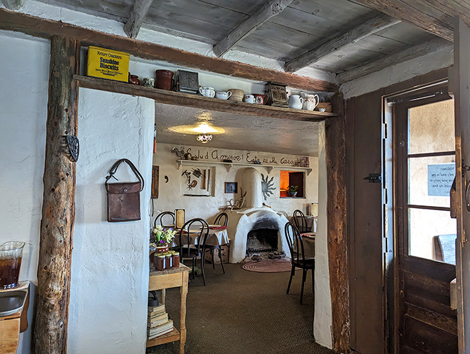 Step inside and feel the warmth of history. This cozy interior, with its adobe fireplace, whispers tales of family dinners past.