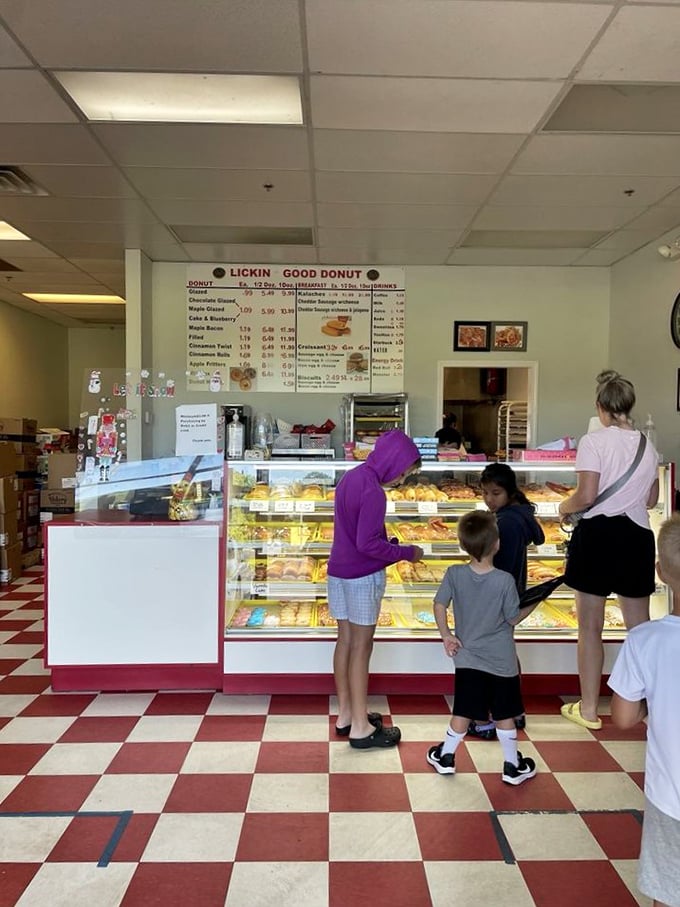 Step into a time machine of taste! The classic checkerboard floor sets the stage for a nostalgic journey through donut heaven.