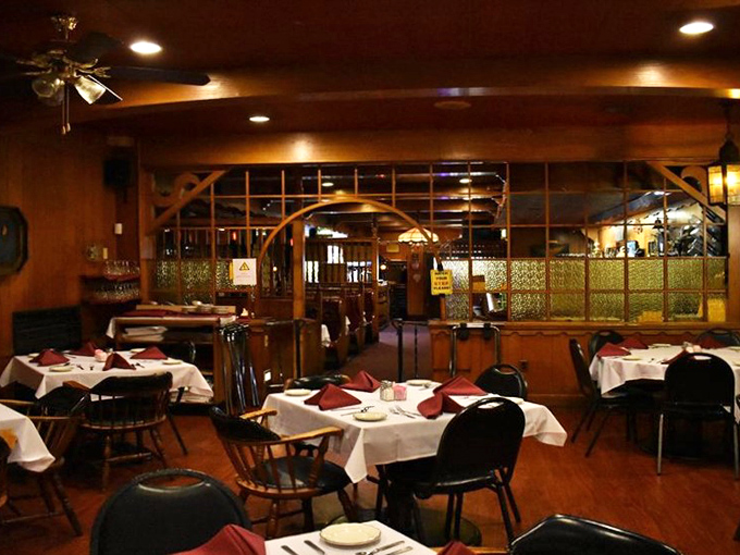 Step into a time capsule of comfort! This warm, wood-paneled dining room whispers tales of countless memorable meals shared.