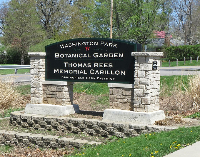"Welcome to paradise," the sign seems to whisper. This stone gateway promises a journey through botanical bliss.