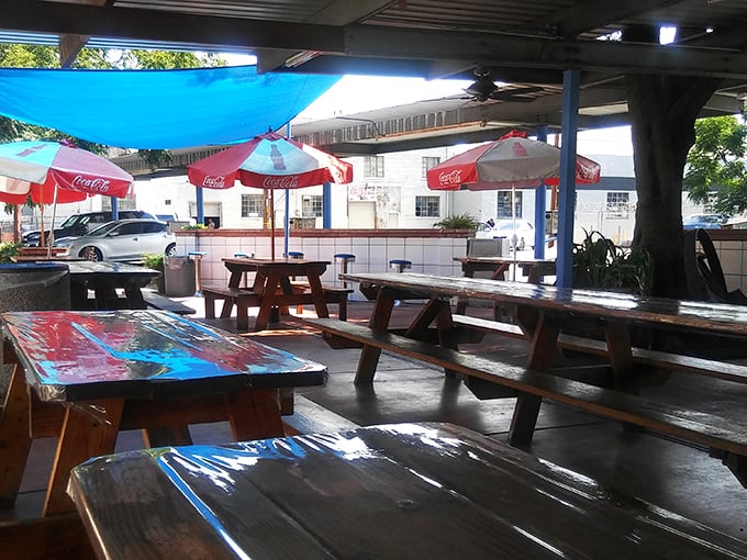 Coca-Cola umbrellas and weathered picnic tables - this isn't just dining, it's a trip to simpler times. Pass the ketchup, and the memories!