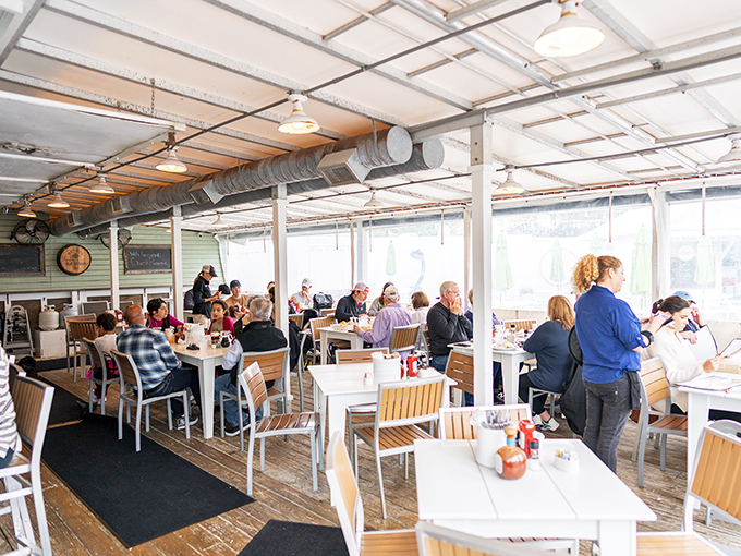 Step inside and feel the buzz! This isn't just a dining room; it's a Southern living room where strangers become friends over shared plates and laughter.