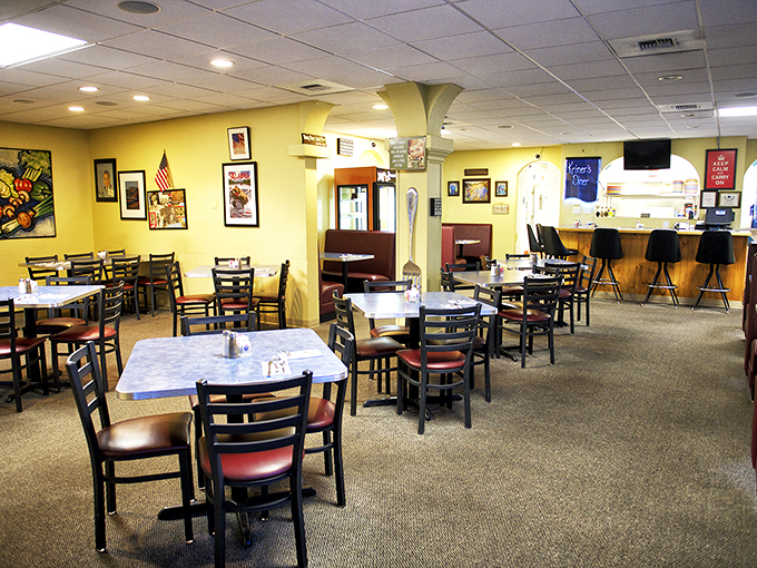 Step into a time capsule of comfort! Kriner's sunny yellow walls and eclectic decor create an atmosphere that's part grandma's kitchen, part local art gallery.