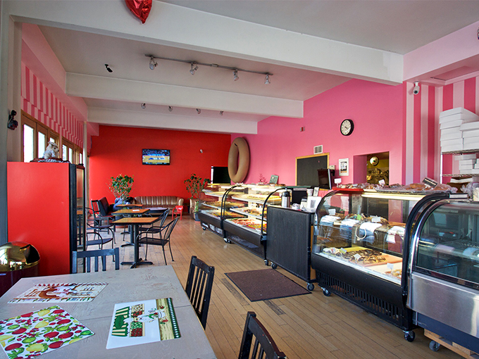 Step into a Candyland for grown-ups! The bakery's interior explodes with vibrant pinks and reds, making you feel like you've walked into a 1950s soda shop designed by Lisa Frank.