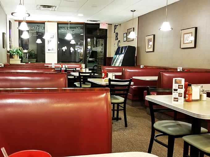 Step into a time capsule of comfort. This cozy interior, with its red vinyl booths, is where Cincinnati's chili dreams come true.