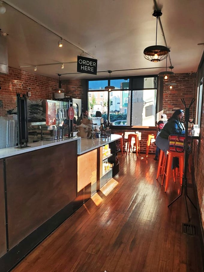 Step into chicken paradise! This cozy interior, with its warm wood and brick, feels like your coolest friend's kitchen &ndash; if that friend was a fried chicken wizard.