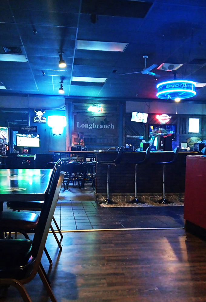 Step into a world where neon dreams and comfort food collide. The Longbranch's interior is like a warm hug from your coolest uncle.