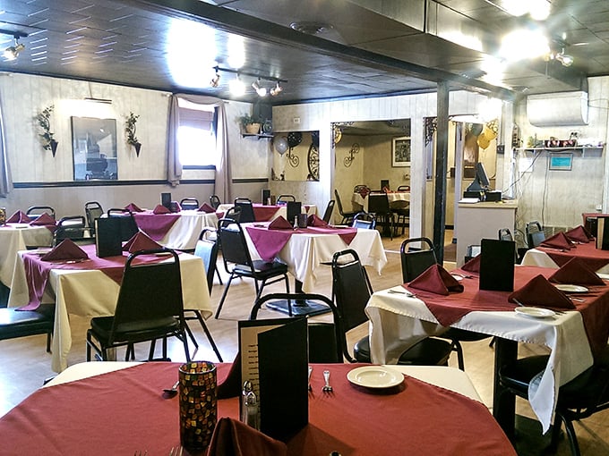Step into a time capsule of comfort! The dining room's mix of burgundy and white tablecloths creates an atmosphere that's part Norman Rockwell painting, part your favorite aunt's living room.