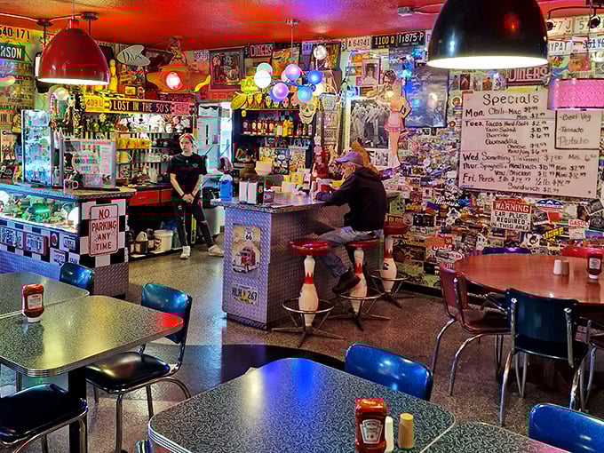Sensory overload alert! This diner's interior is a kaleidoscope of nostalgia, where every nook and cranny tells a story of America's love affair with chrome and neon.