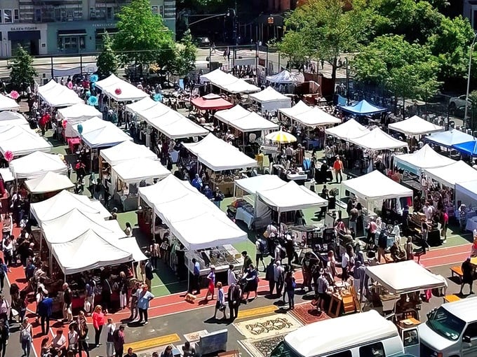 Grand Bazaar NYC: Where Manhattan's hustle meets the charm of an open-air market. Treasures await under a sea of white tents.