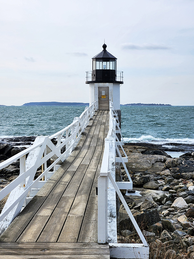 A lighthouse that thinks it's a catwalk! Marshall Point's wooden walkway stretches out like nature's red carpet.