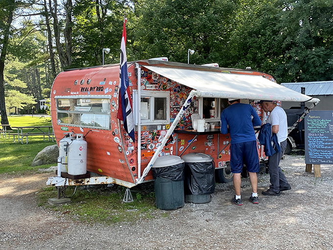 Smokin' Good BBQ: This vintage camper's got more stickers than my grandkid's laptop! A rolling feast for the eyes and the stomach.